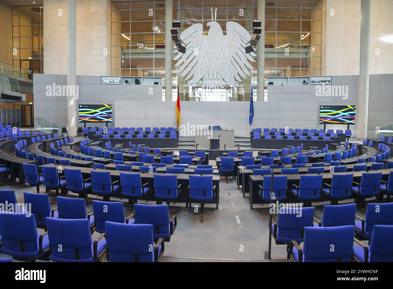 The plenary chamber of the Bundestag with many blue seats and the ...
