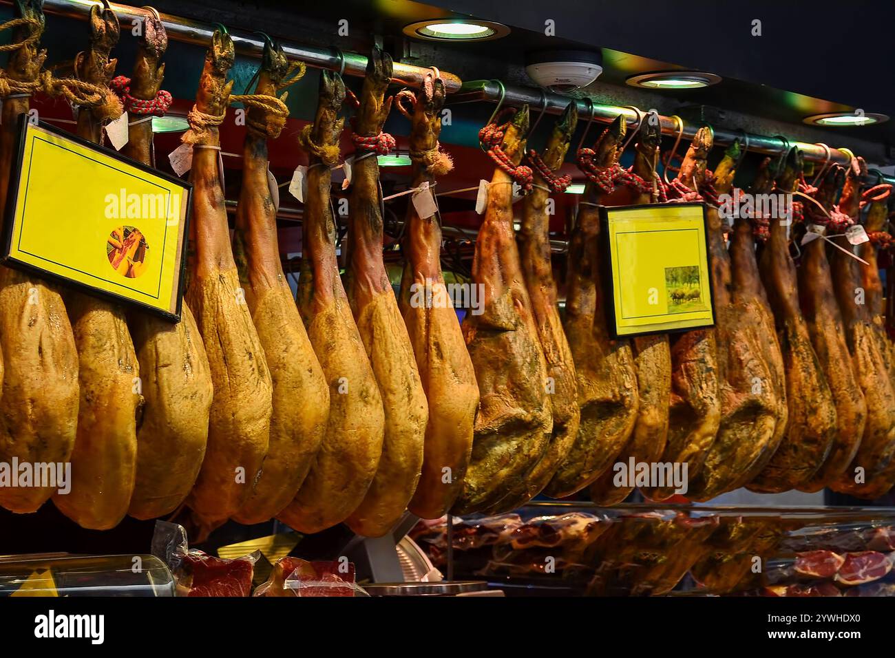 Cured iberian ham legs hanging in a market stall, ready for sale Stock ...