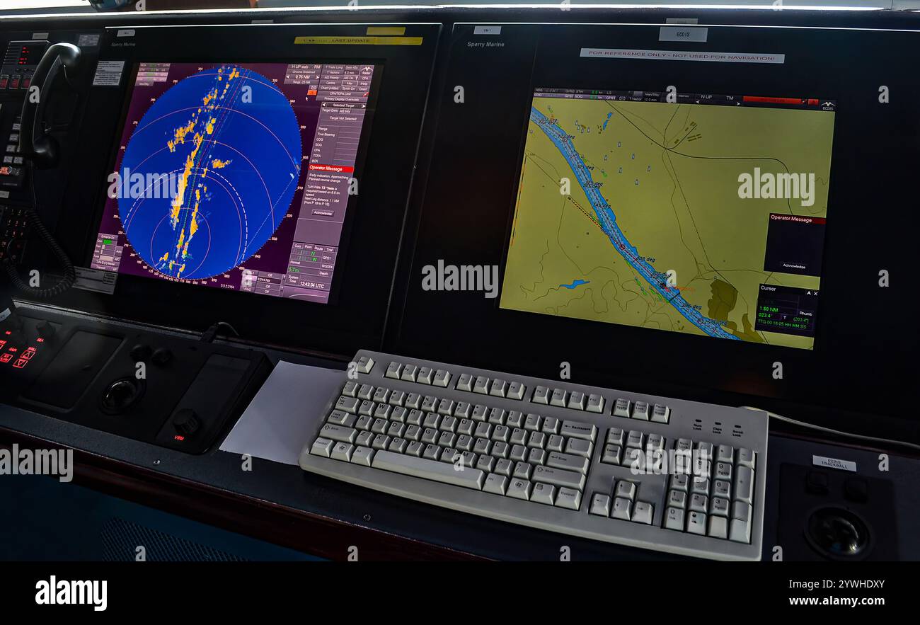 Ship's bridge with navigation control panel displaying radar and gps ...