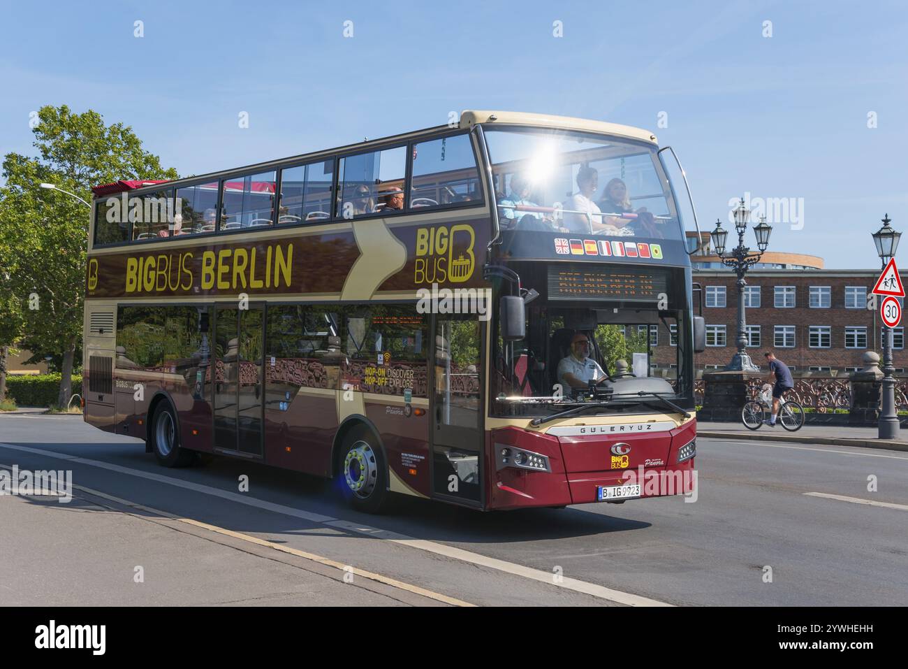 A red Berlin sightseeing double-decker bus on a street, full of ...
