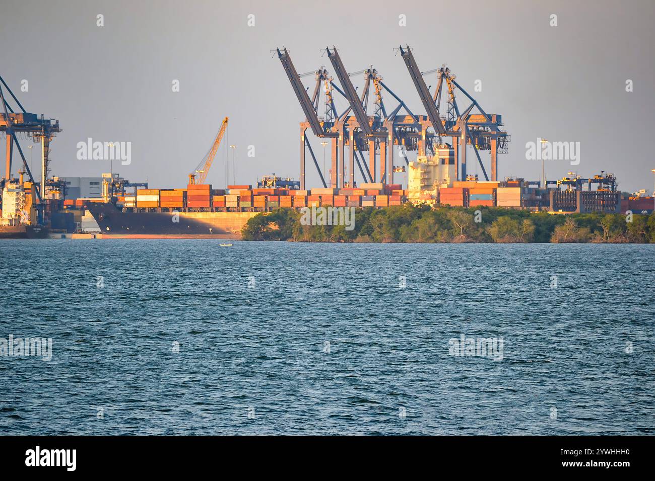 Large cranes tower over stacked shipping containers at a major port ...