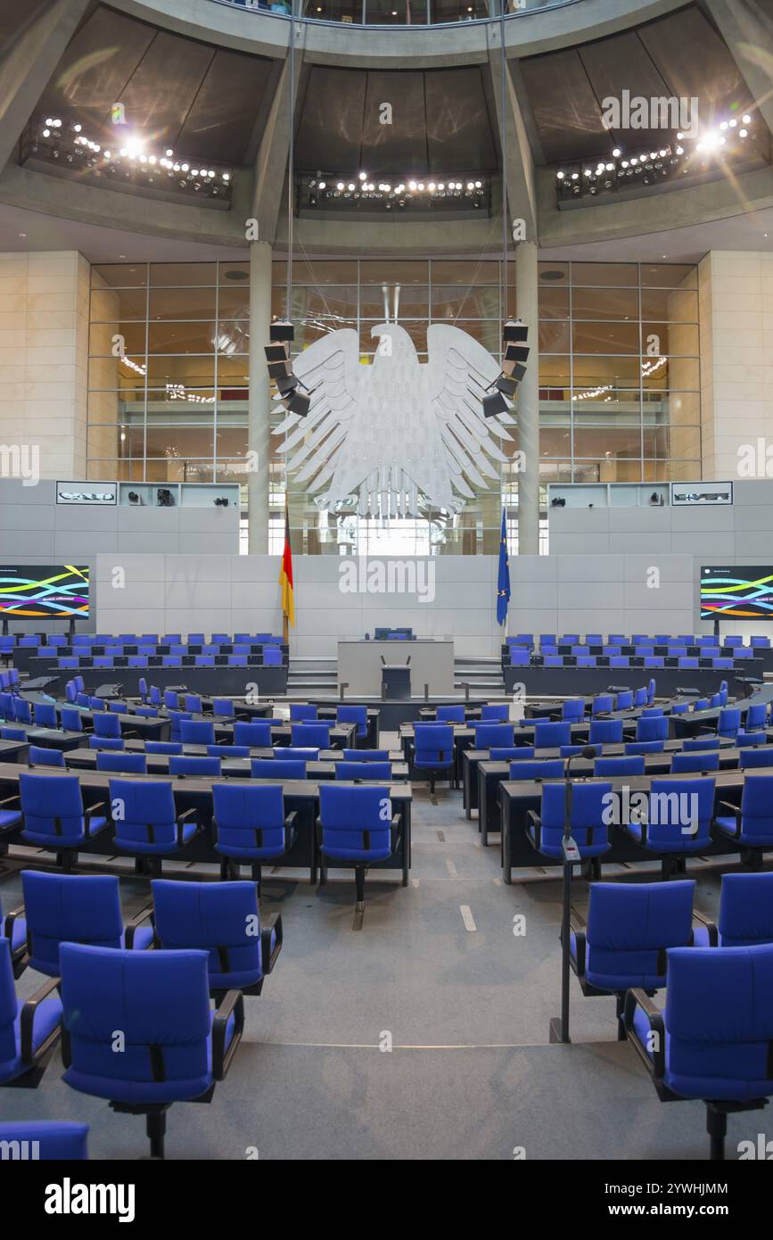 Modern plenary chamber with blue chairs and large eagle emblem, German ...