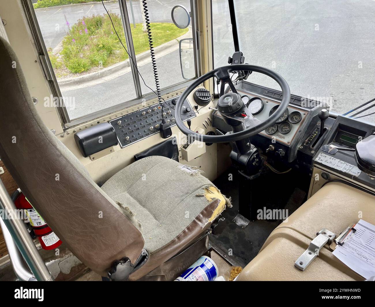 Interior view of an old bus with a damaged seat and dashboard, Alaska ...