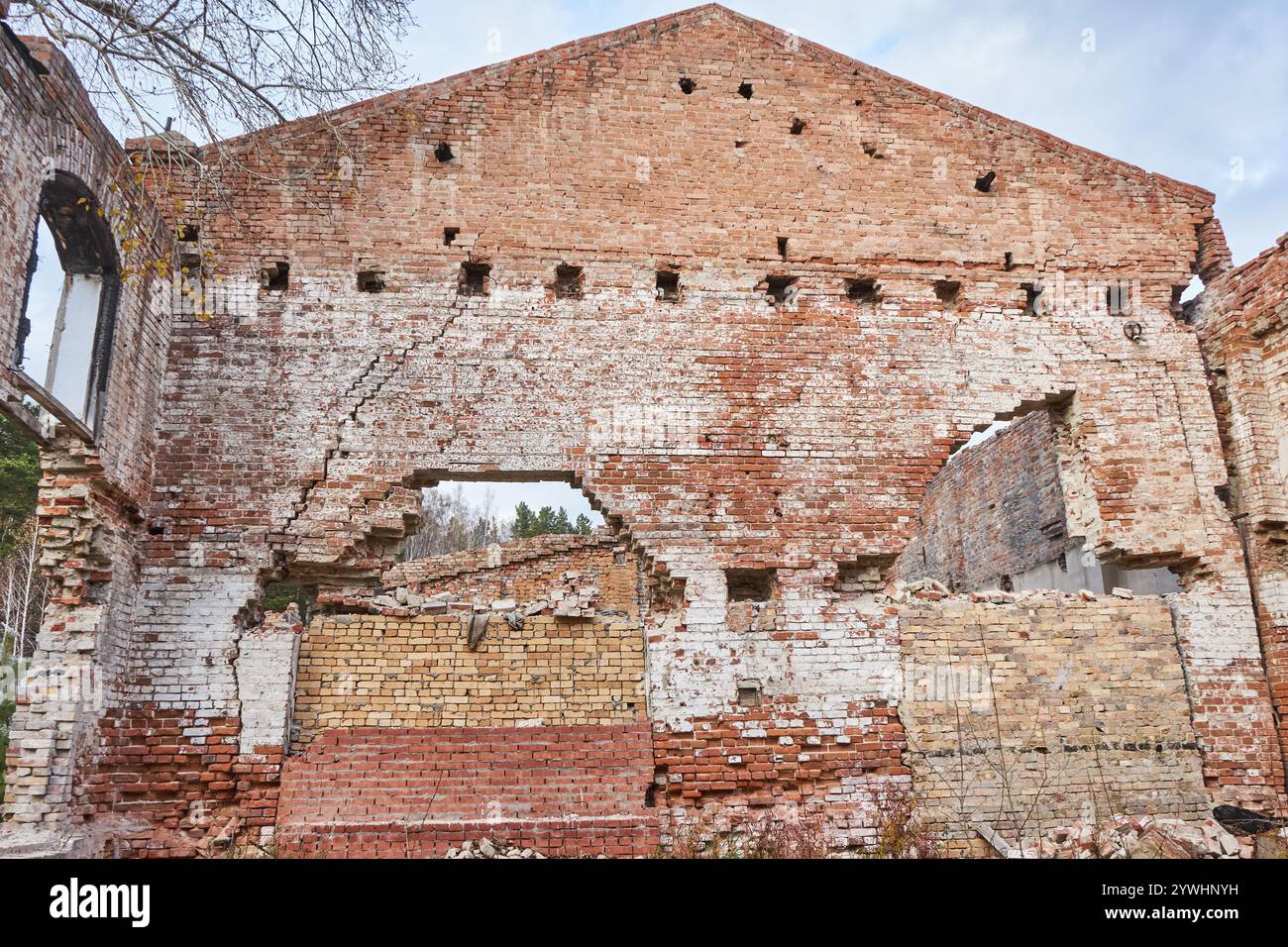 Abandoned destroyed brick building built in 1912. Wall with windows of ...