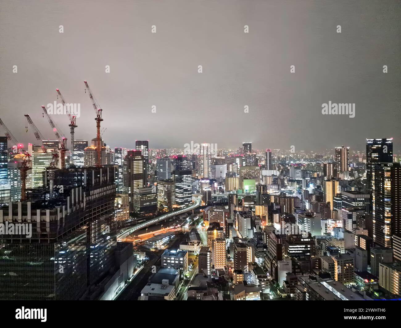 Osaka's illuminated skyscrapers and construction cranes dominate the ...