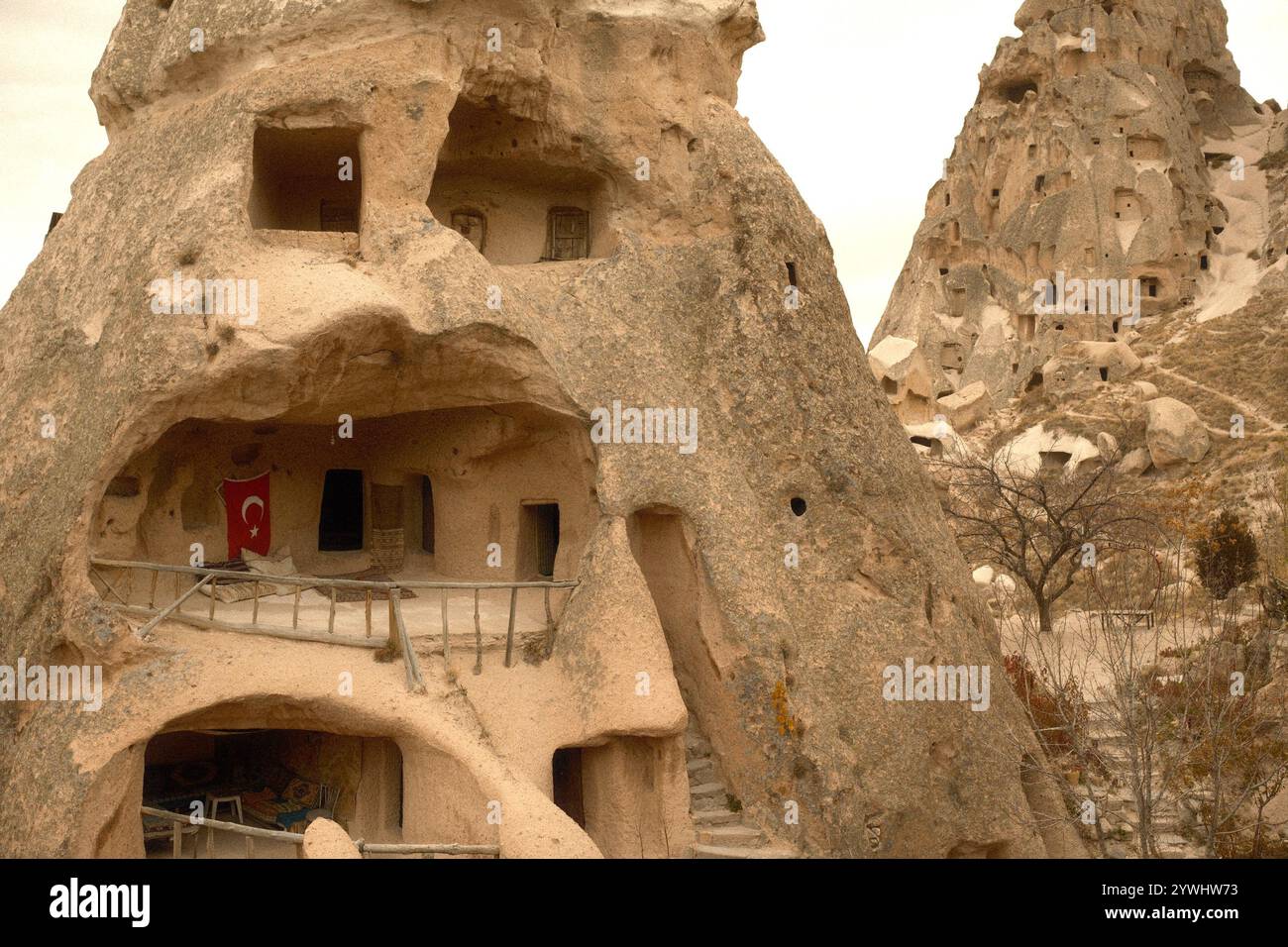 A cave dwelling house chimney with a unique balcony decorated with ...
