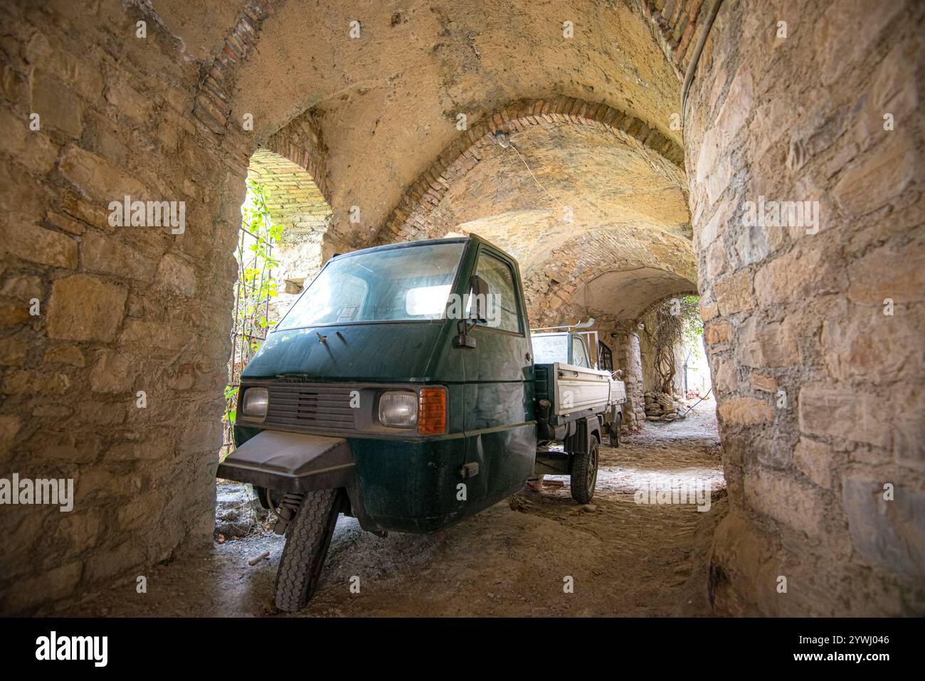 Unique three-wheeled vehicle parked in ancient stone ruins during ...