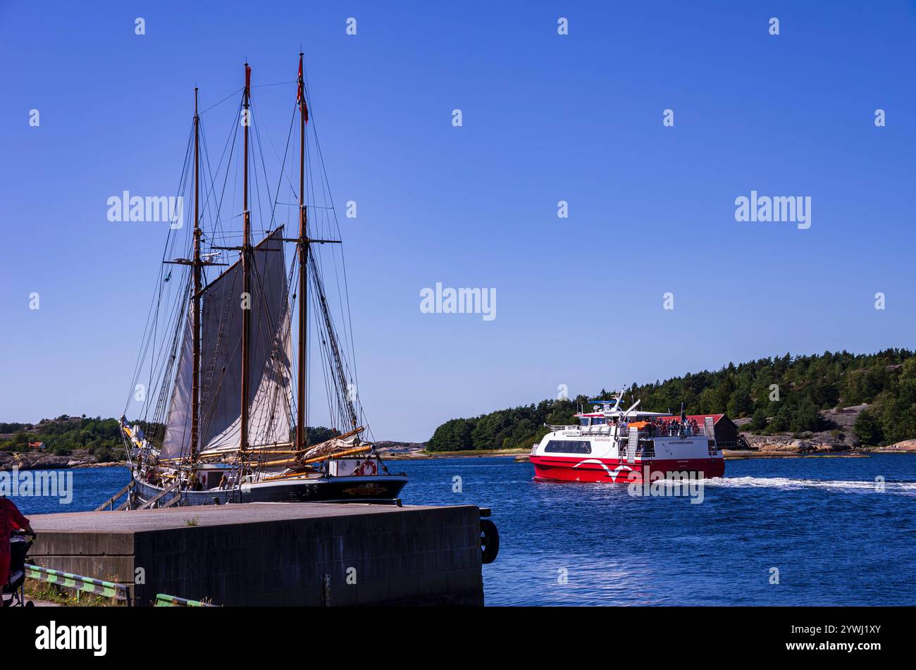 The three-masted schooner, the SS SVANEN, has cast off from the quay ...