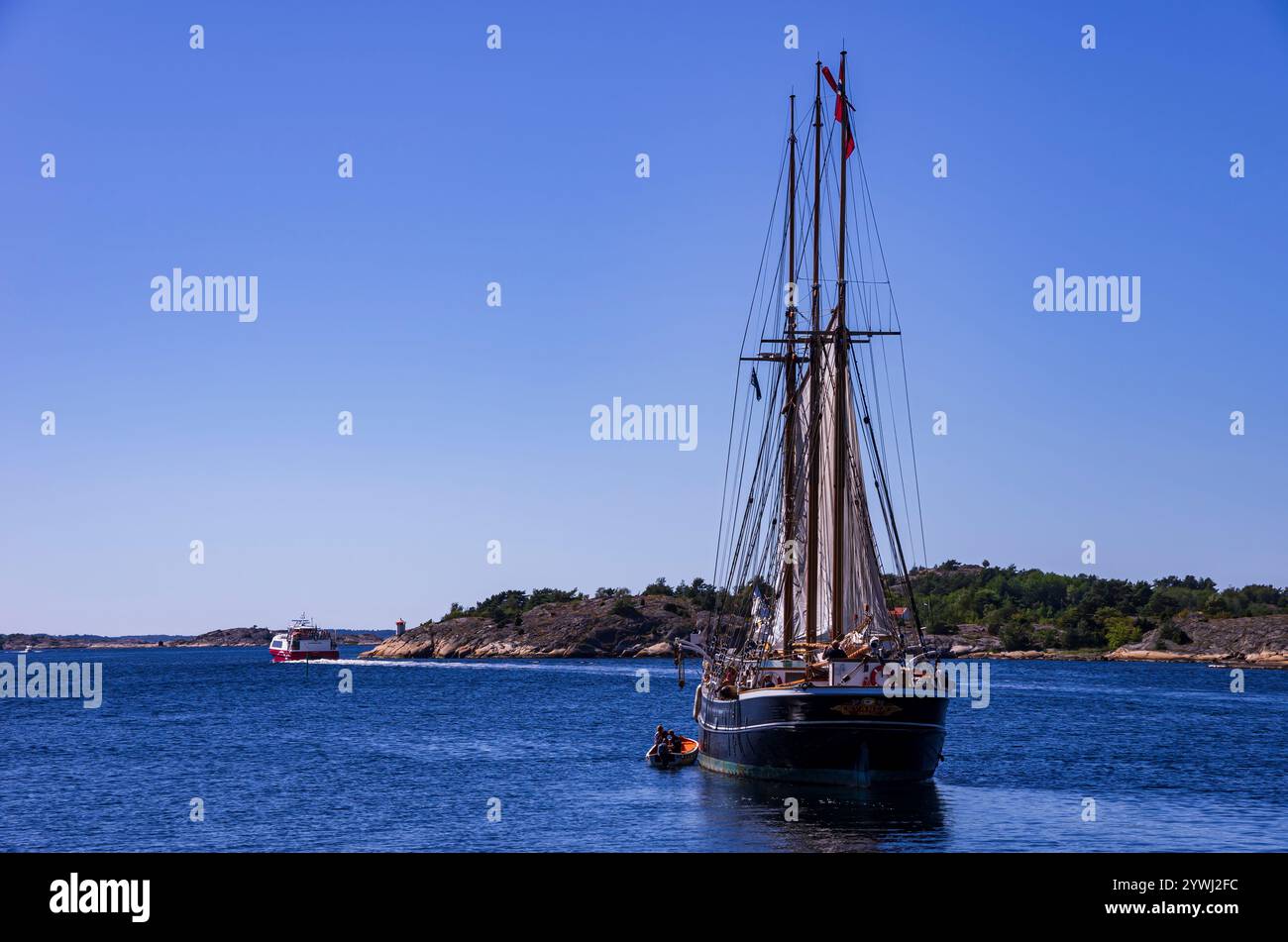 The three-masted schooner, the SS SVANEN, has cast off from the quay ...