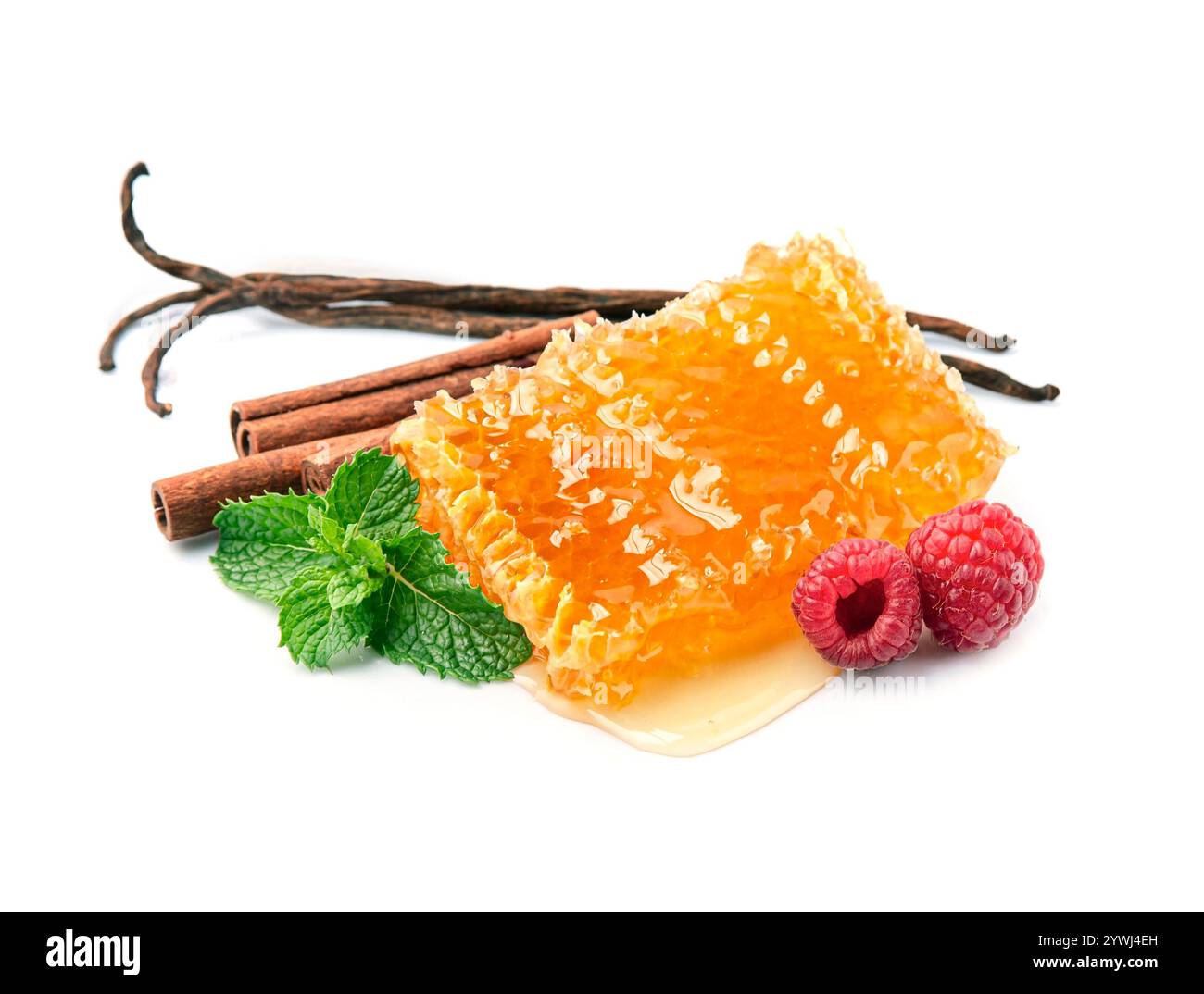 Honeycomb with cinnamon , mint , vanilla and raspberry on white ...