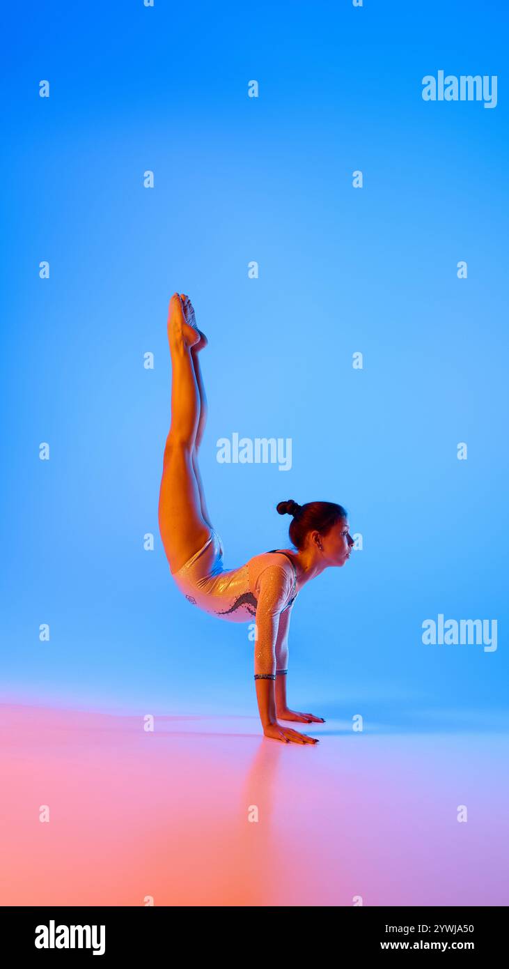 Young female gymnast executes challenging routine to build core ...