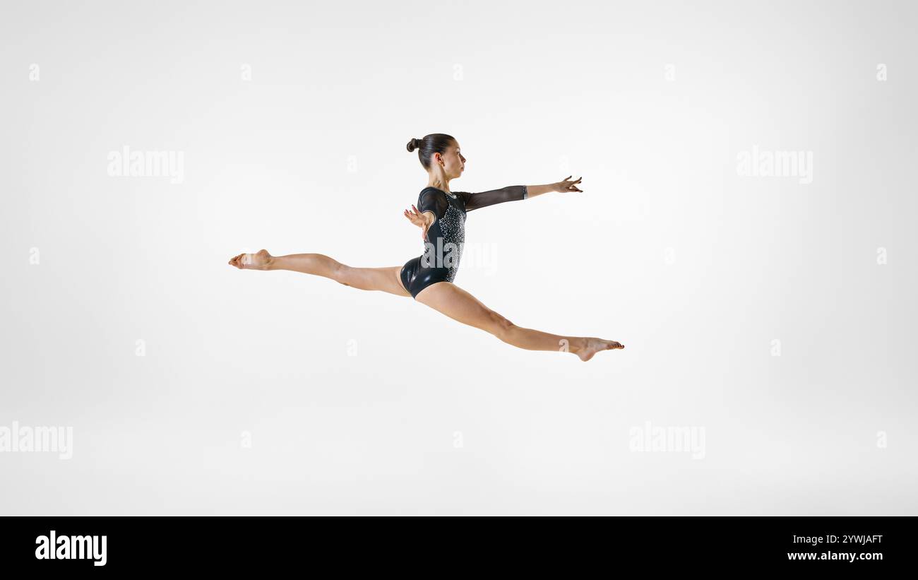 Side view photo of young female girl jumps, splits in mid-air in motion ...