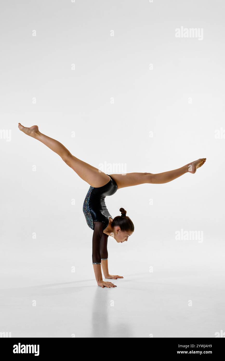 Gymnast performs steady movements, enhancing flexibility and posture ...