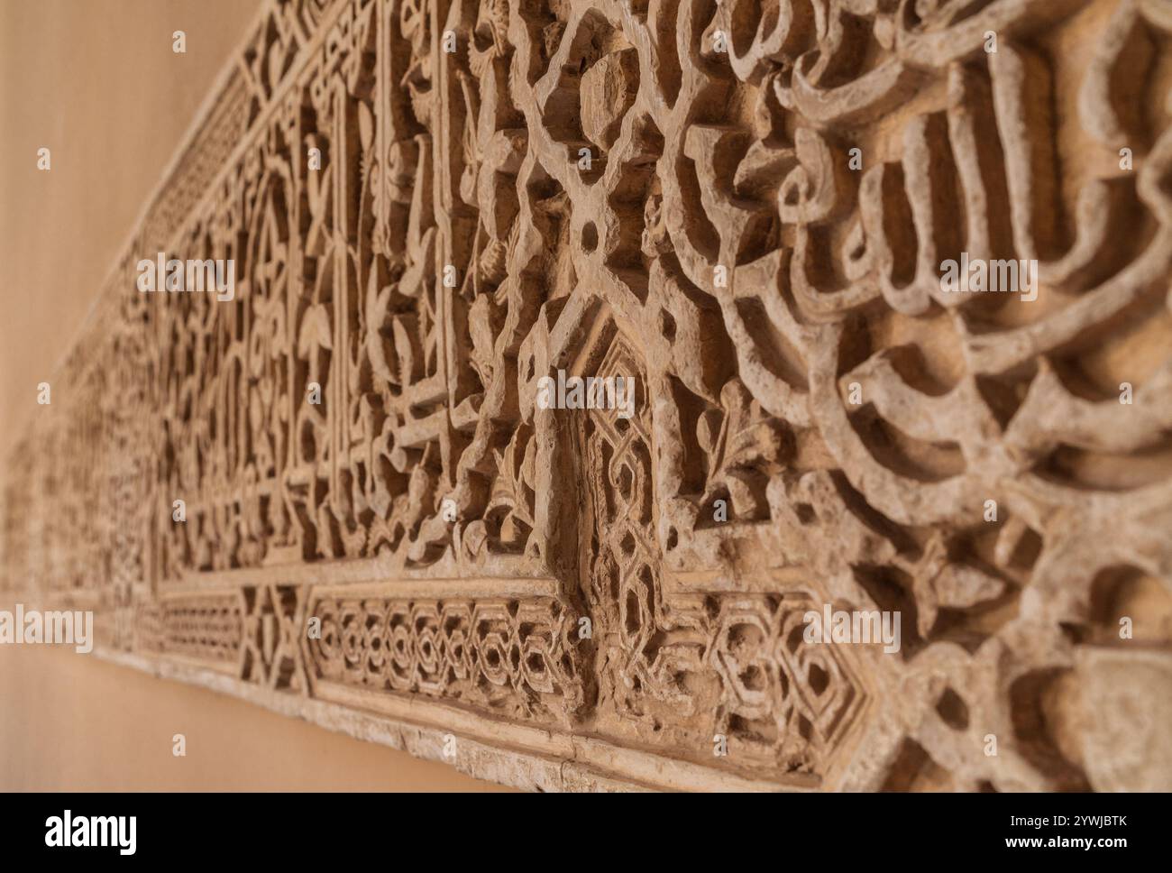 Details of stucco decoration with an Arabic writings painted in blue on ...