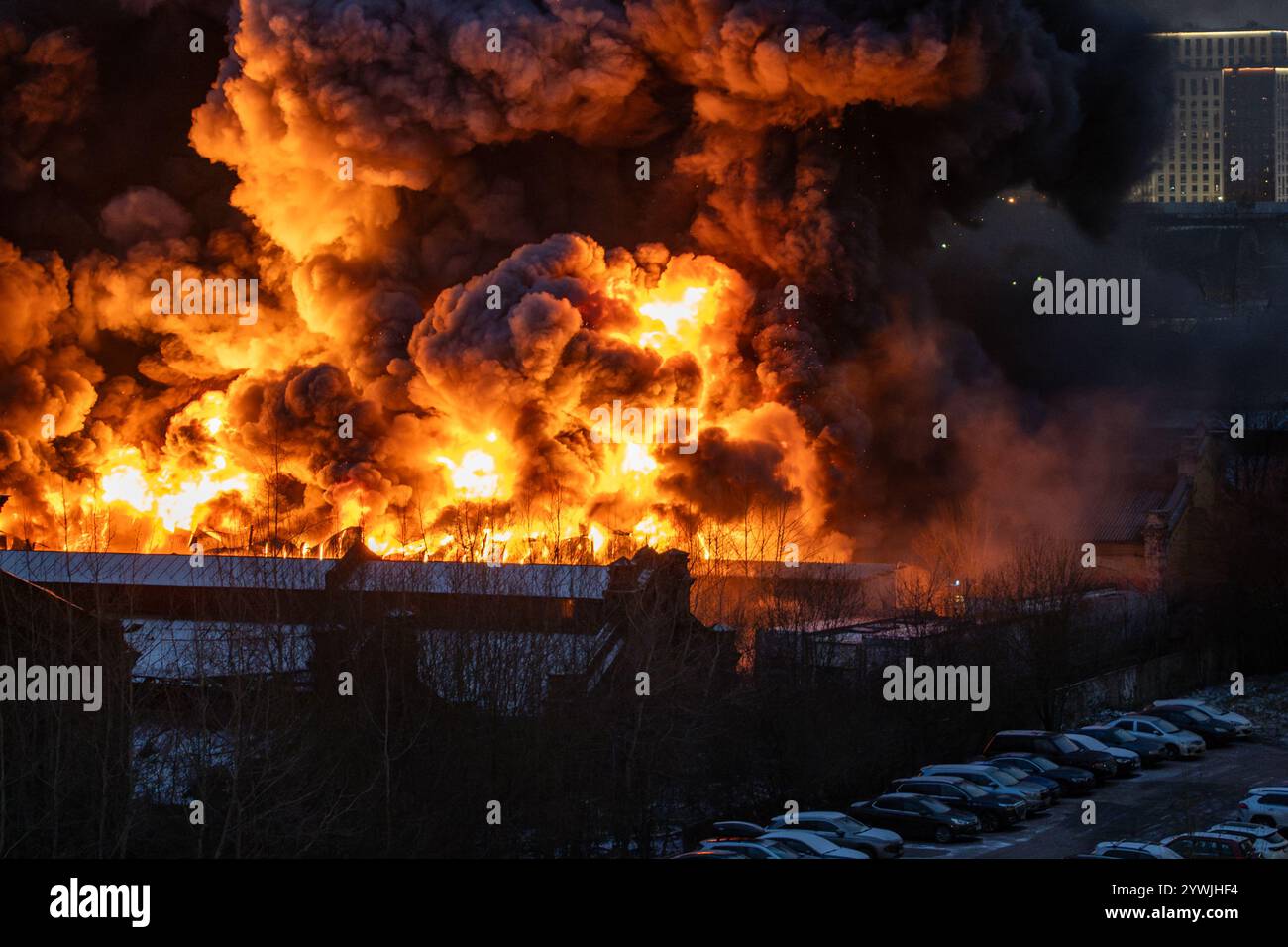 Orange smoke from flames or fires of warehouses and industrial building ...