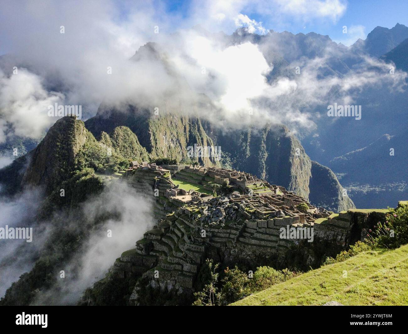 View of ruined Inca city, Machu Picchu with wispy clouds, Andes, Peru ...