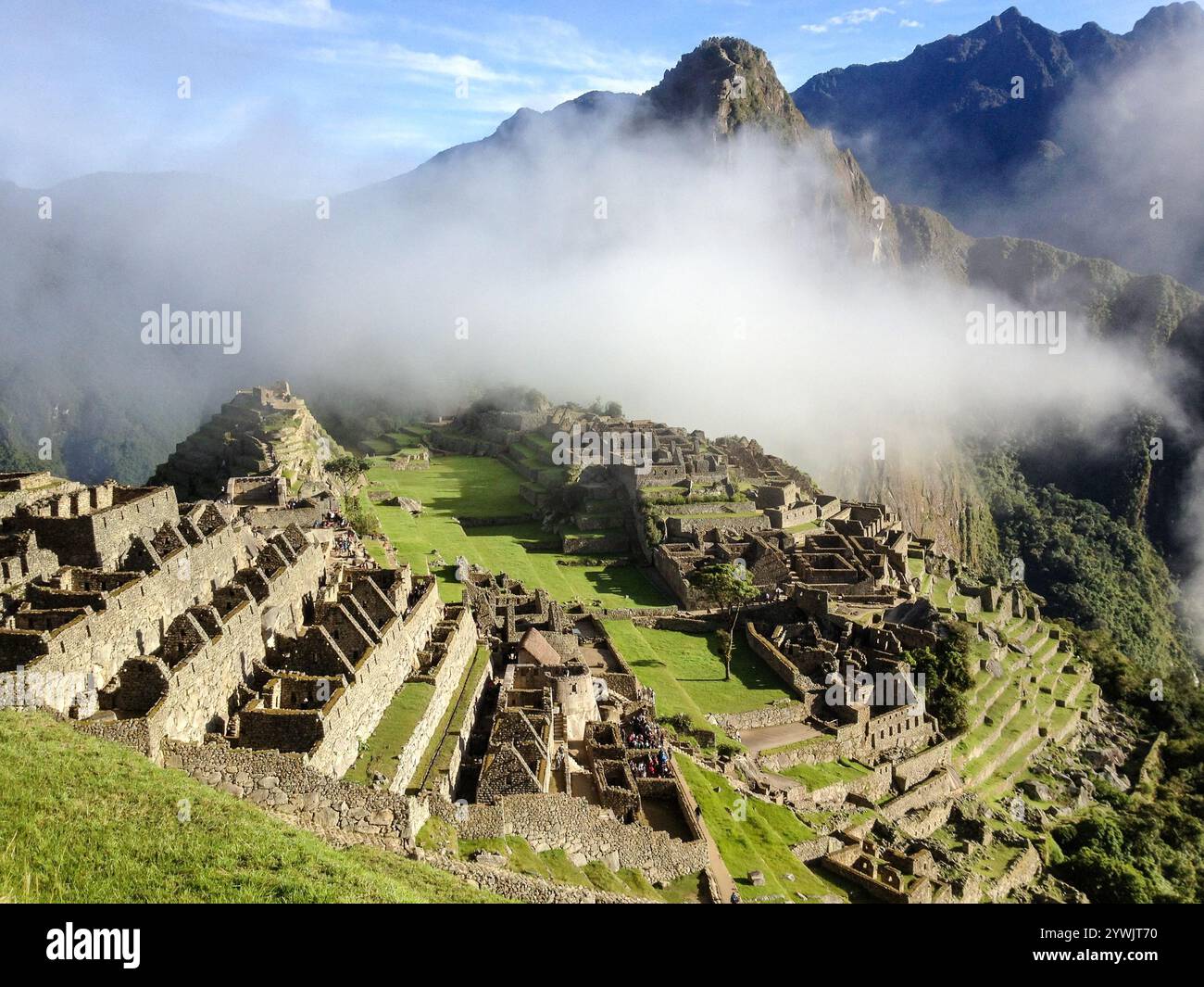 View of ruined Inca city, Machu Picchu with wispy clouds, Andes, Peru ...