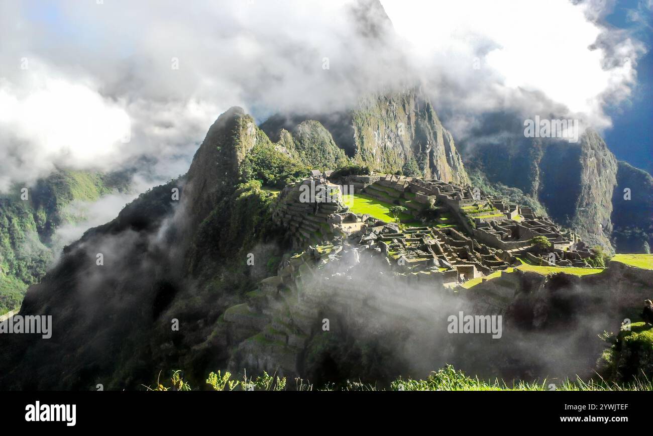 View of ruined Inca city, Machu Picchu with wispy clouds, Andes, Peru ...