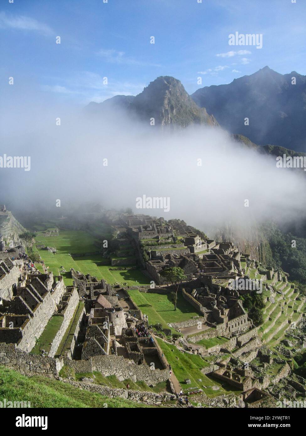 View of ruined Inca city, Machu Picchu with wispy clouds, Andes, Peru ...