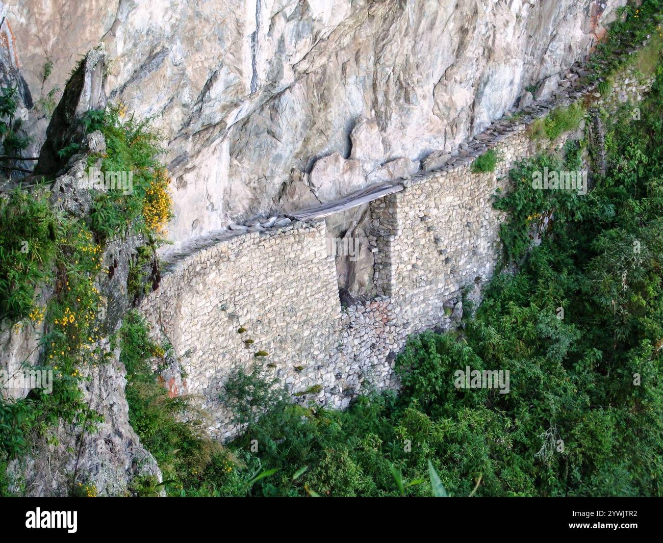 View of dangerous Inca bridge escape route on edge of cliff face (Q ...