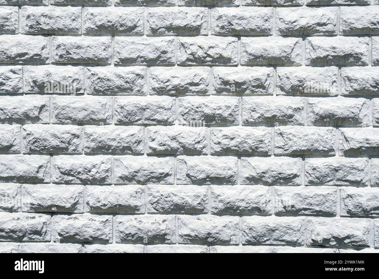 A white brick wall with a white brick in the middle. The brick is white ...
