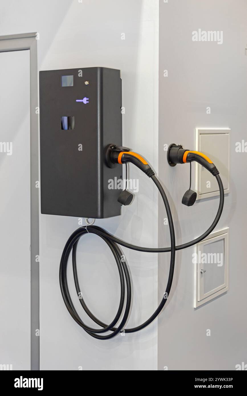 EV Charger Mounted at Wall in Home Garage Stock Photo - Alamy