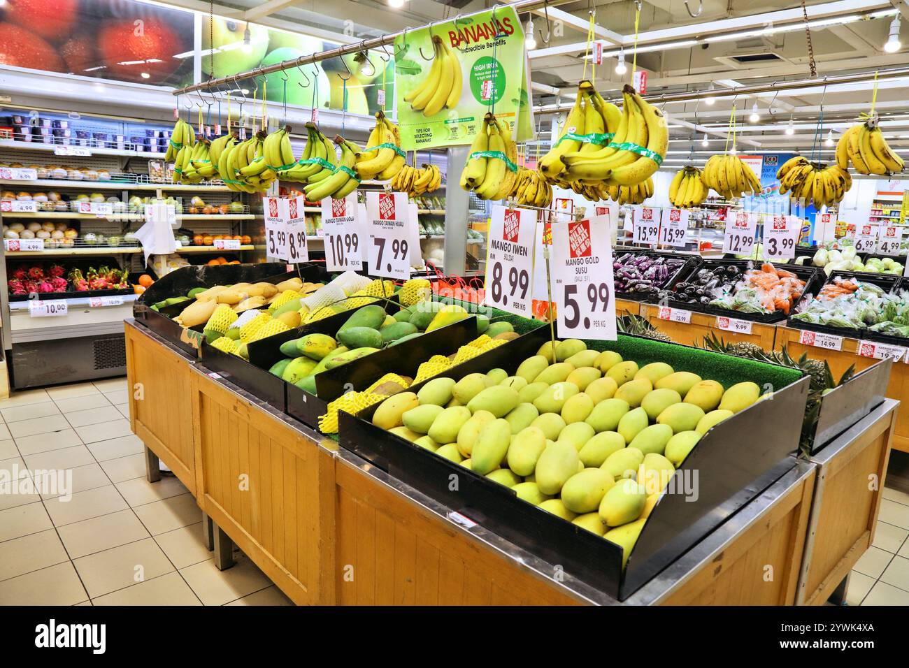 KUALA LUMPUR, MALAYSIA - MARCH 17, 2024: Fruit aisle with mango varieties at a grocery store in ...