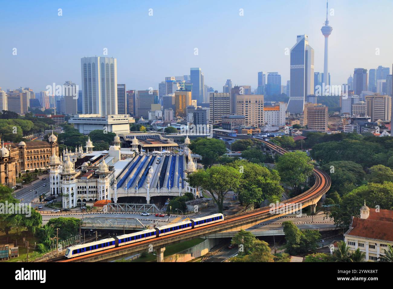 Kuala Lumpur city skyline with LRT public transportation train in ...