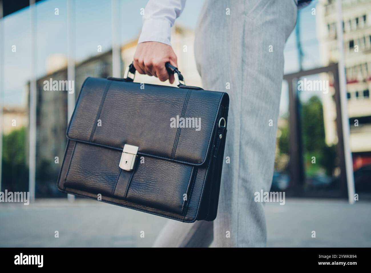 Confident business professional carrying leather briefcase in an urban ...