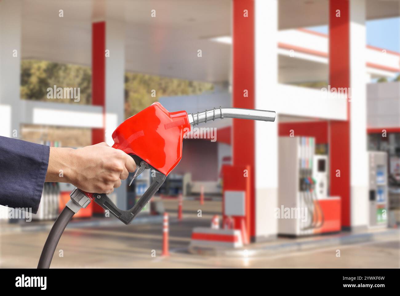 Male hand holding a fuel injection gun at a petrol station Stock Photo ...