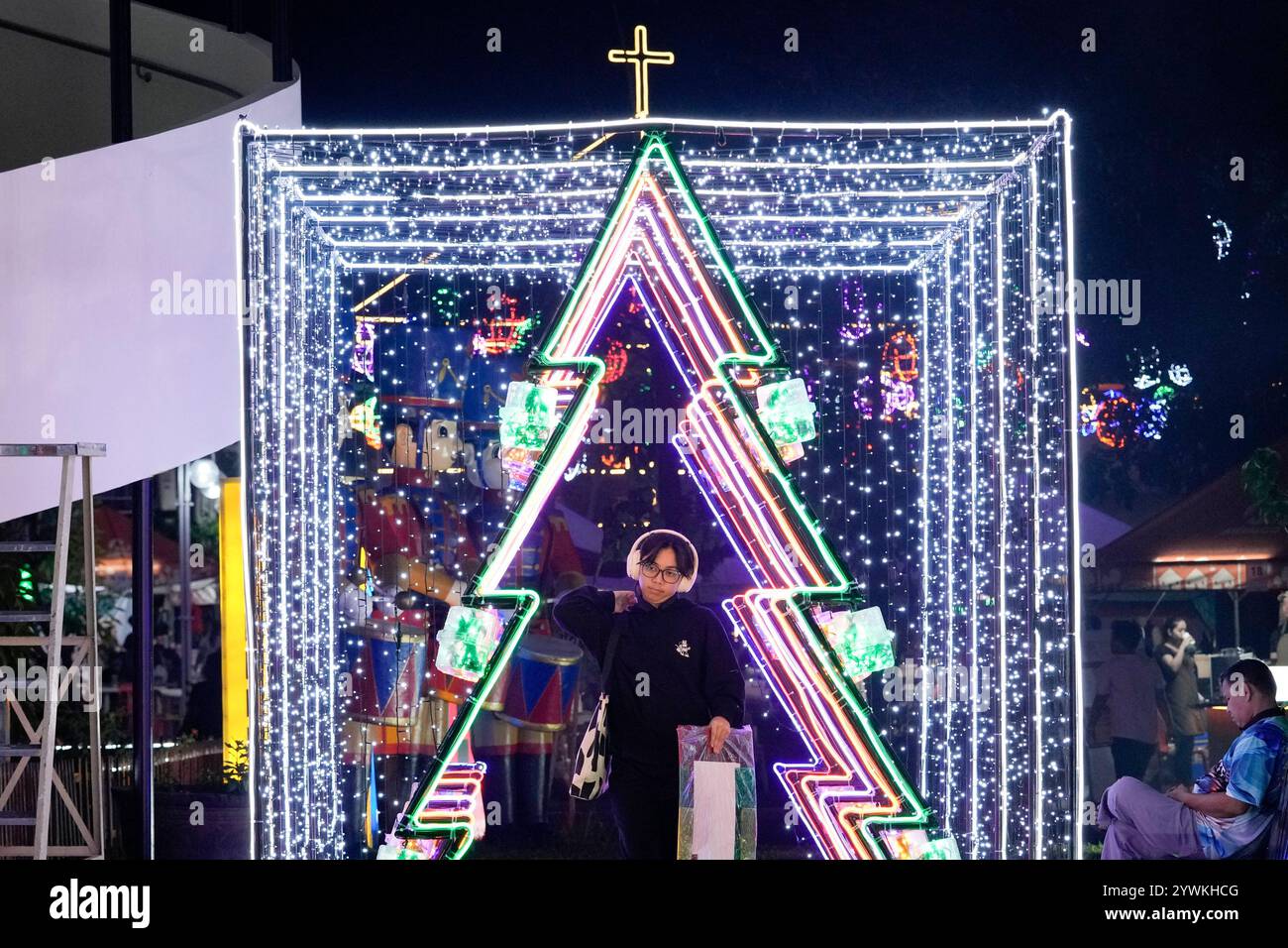 A woman walks along a Christmas light display at Meralco Liwanag Park ...