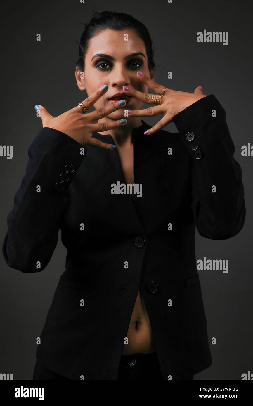 A stunning solo image of a tall female model in a classic black suit ...