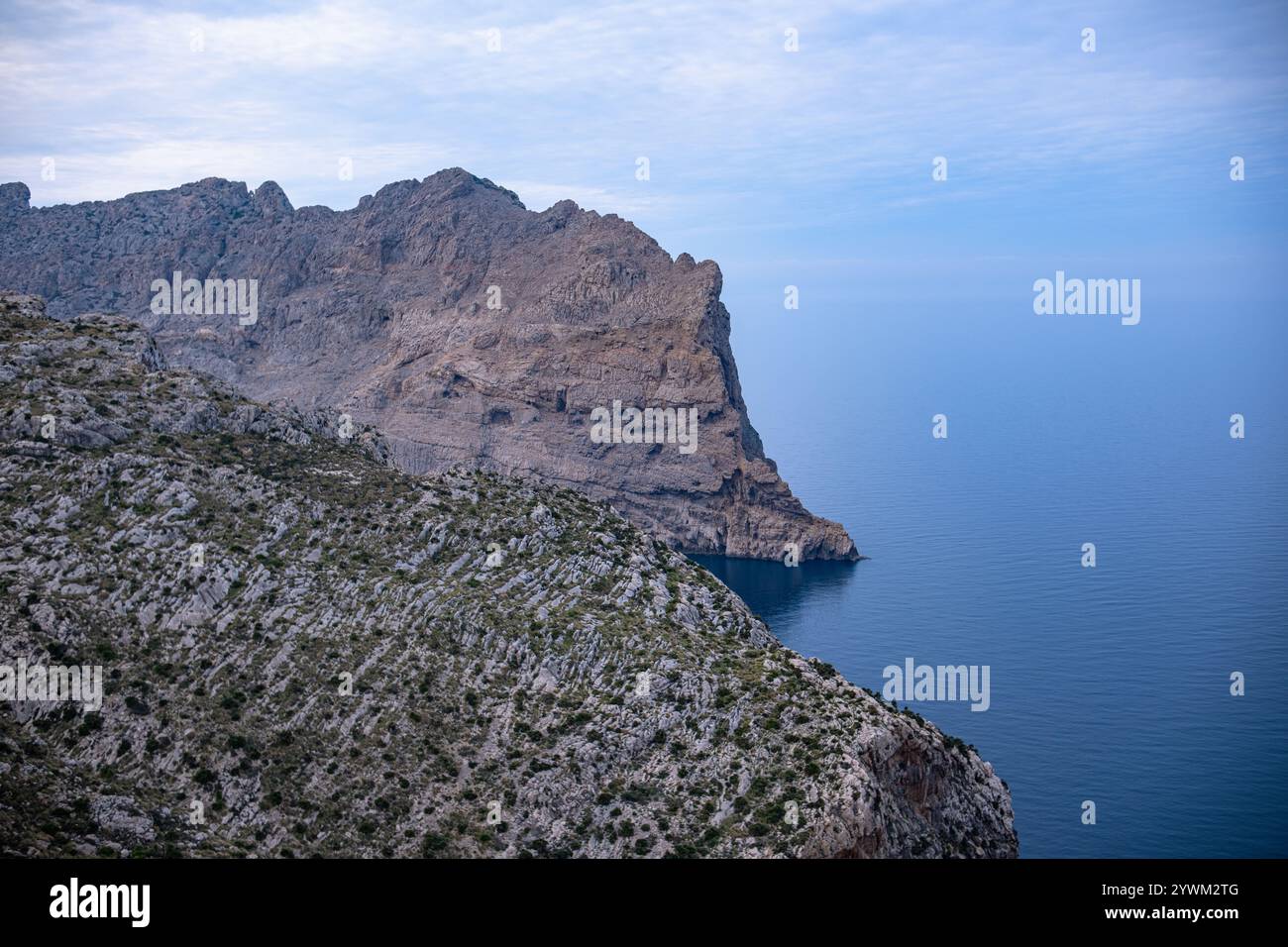 High cliffs jutting out far into the sea. Beautiful seascape. Calm blue ...