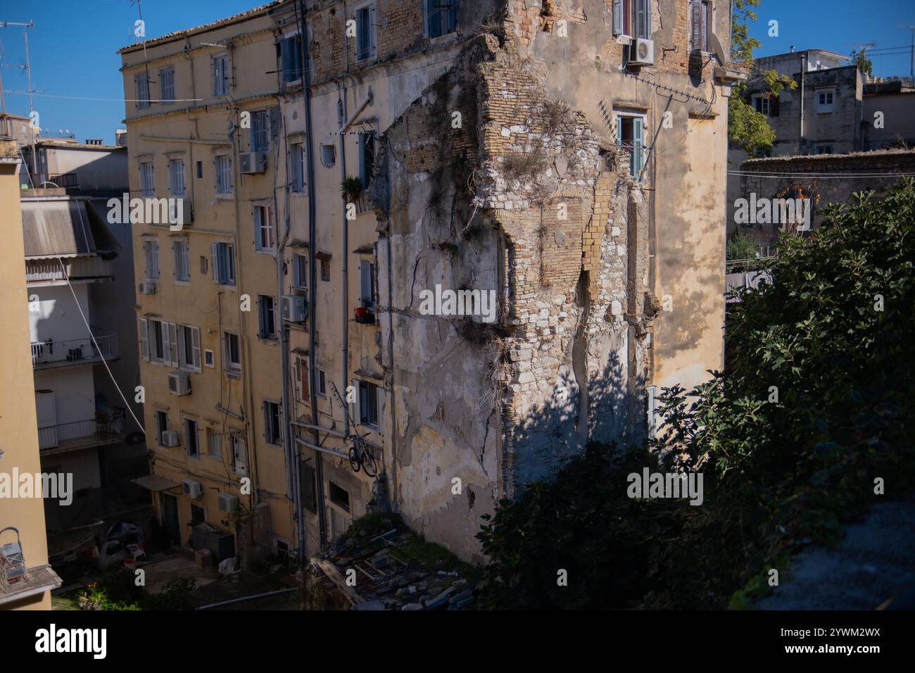 An old multi-story residential building in terrible condition. Chaotic ...