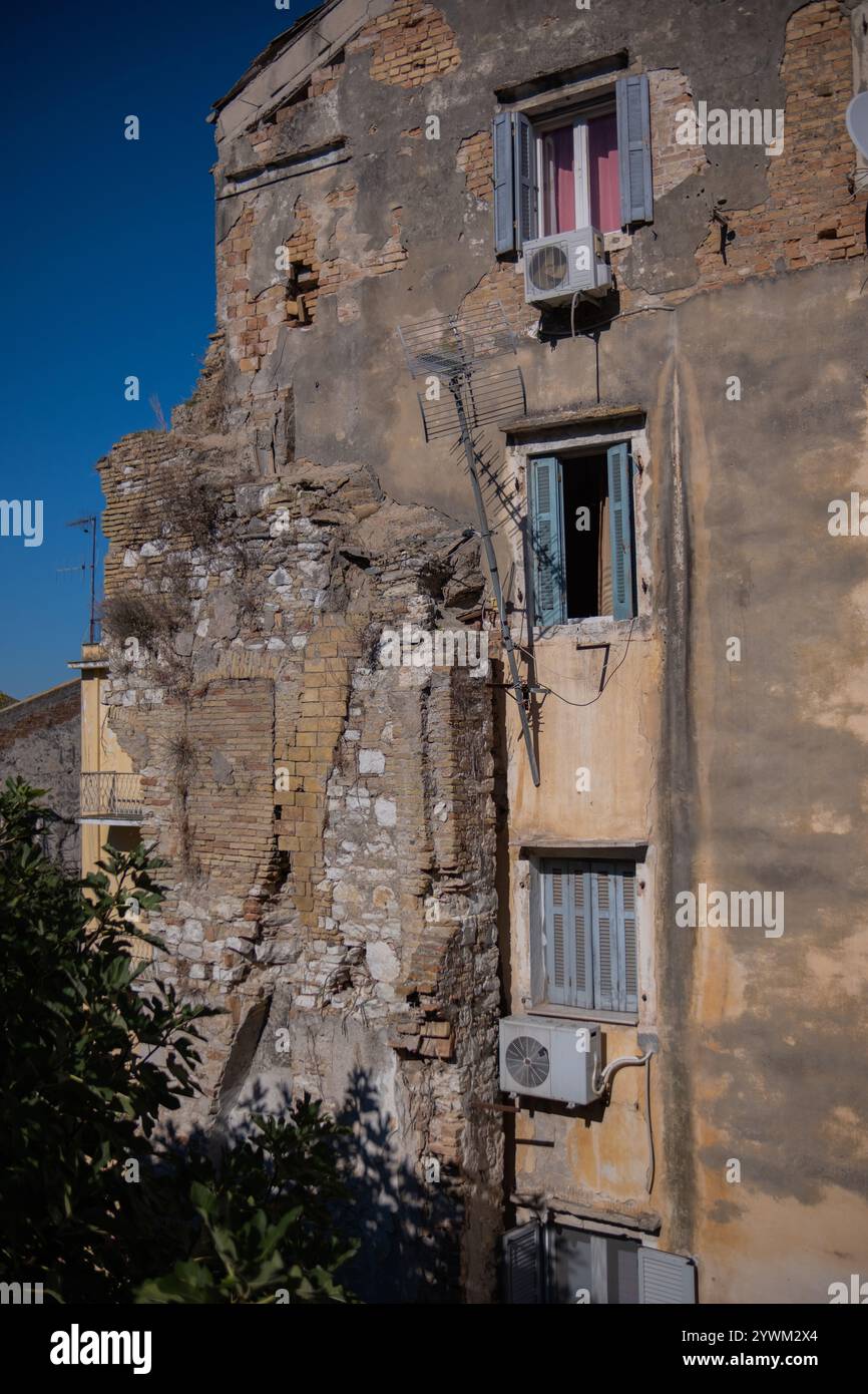 An old multi-story residential building in terrible condition. Chaotic ...