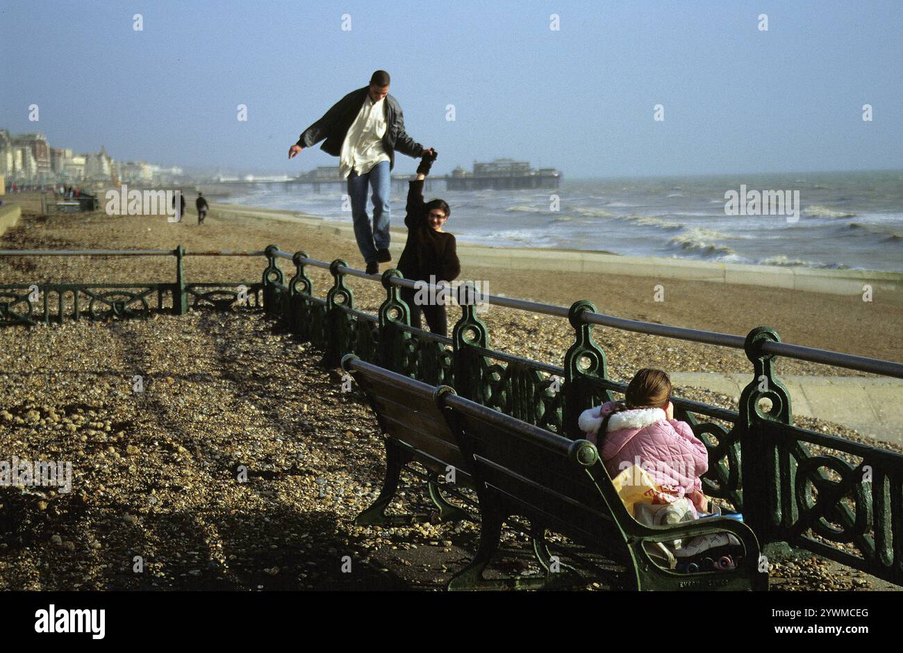 Young man balancing on beach-side railing, Hove, England Stock Photo ...