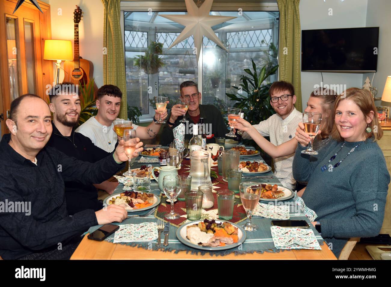 Happy family eating dinner together hi-res stock photography and images ...