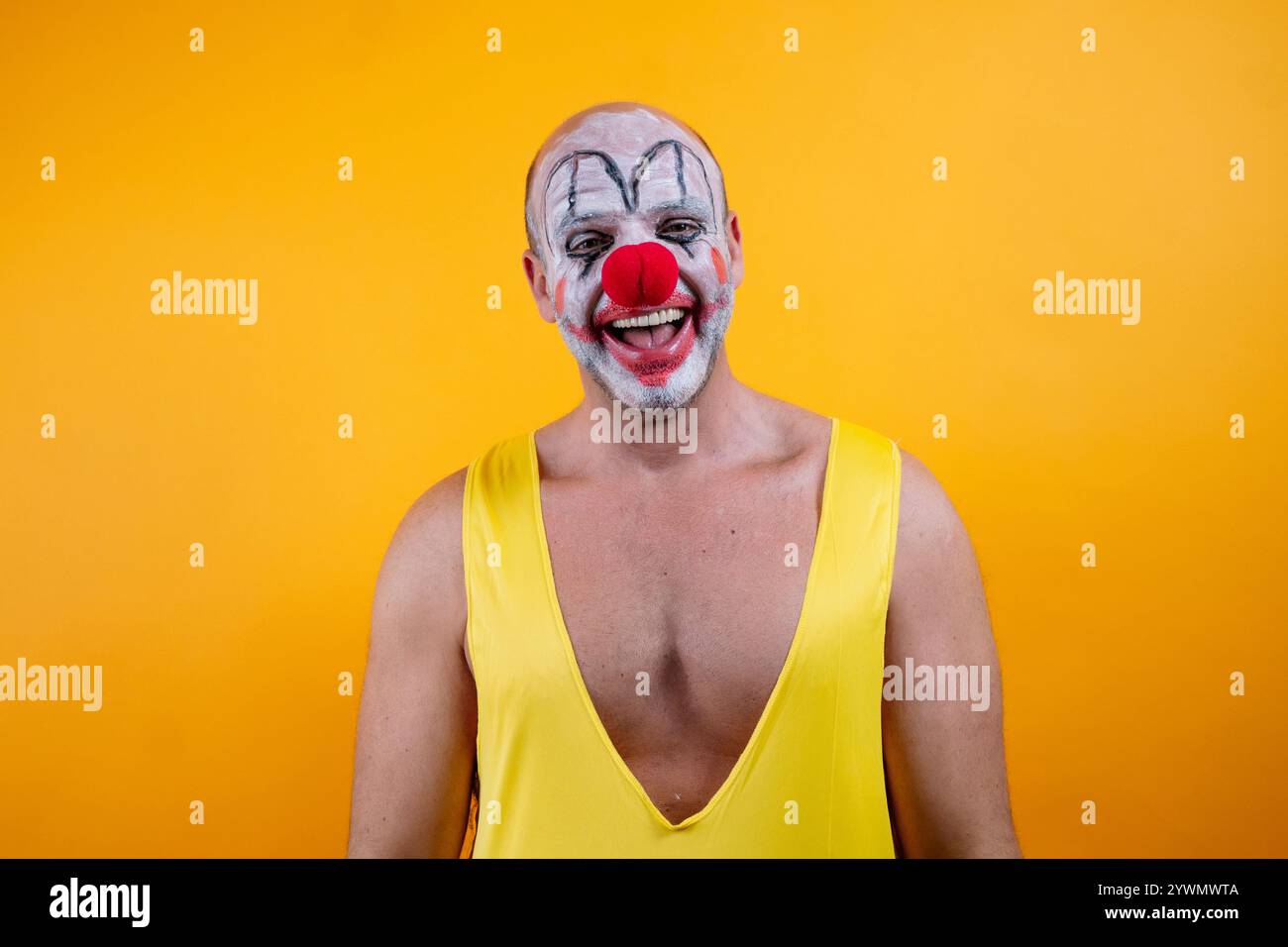 Happy bald clown in yellow smiles at camera Stock Photo - Alamy