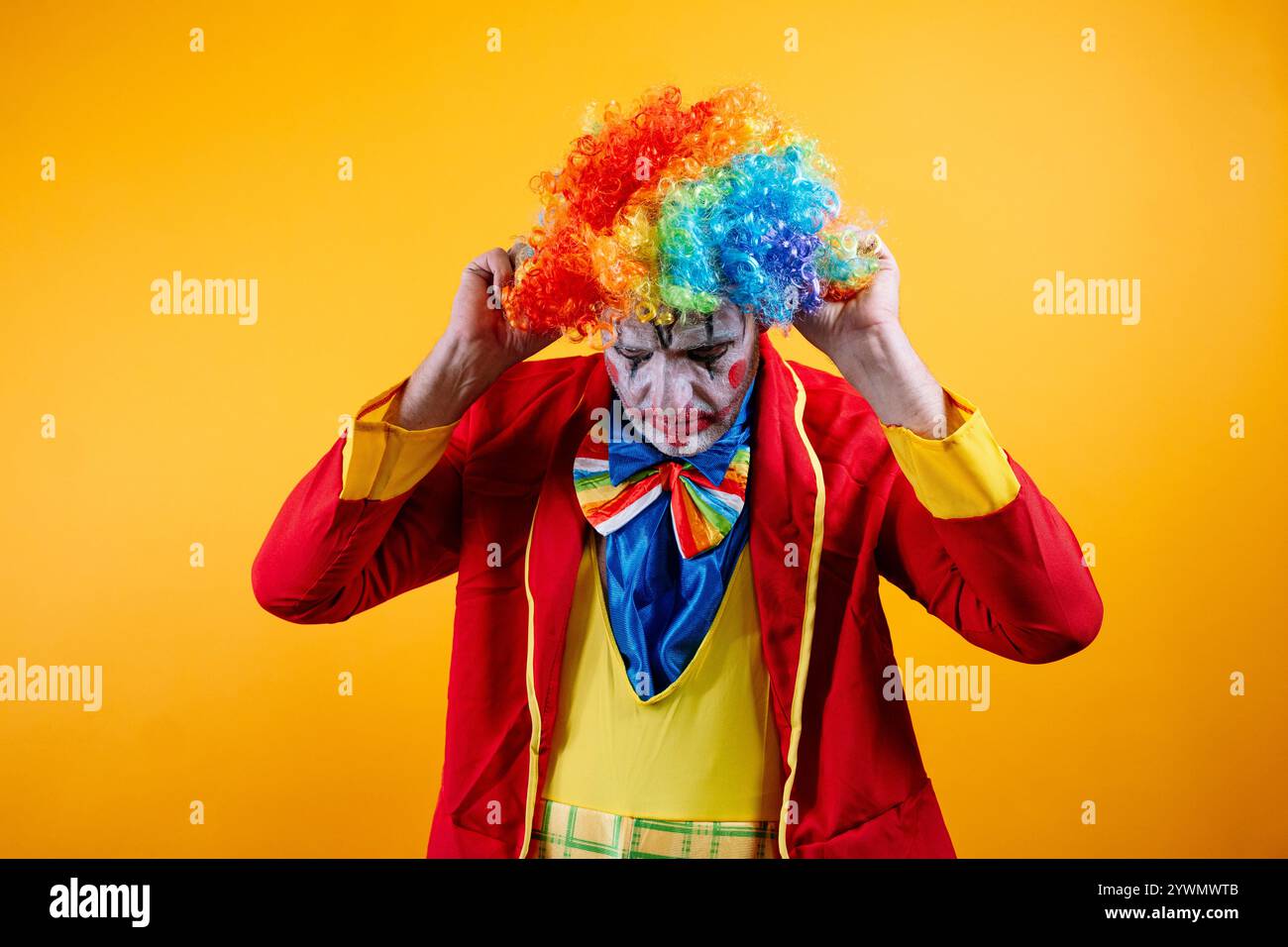 Bald clown dressing up in a colorful costume Stock Photo - Alamy
