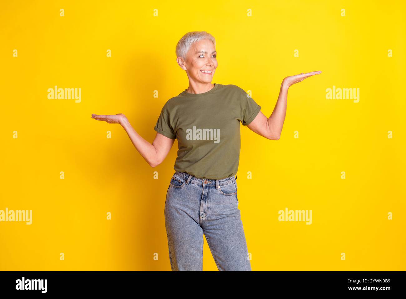 Photo of charming positive woman wear khaki t-shirt comparing arms ...