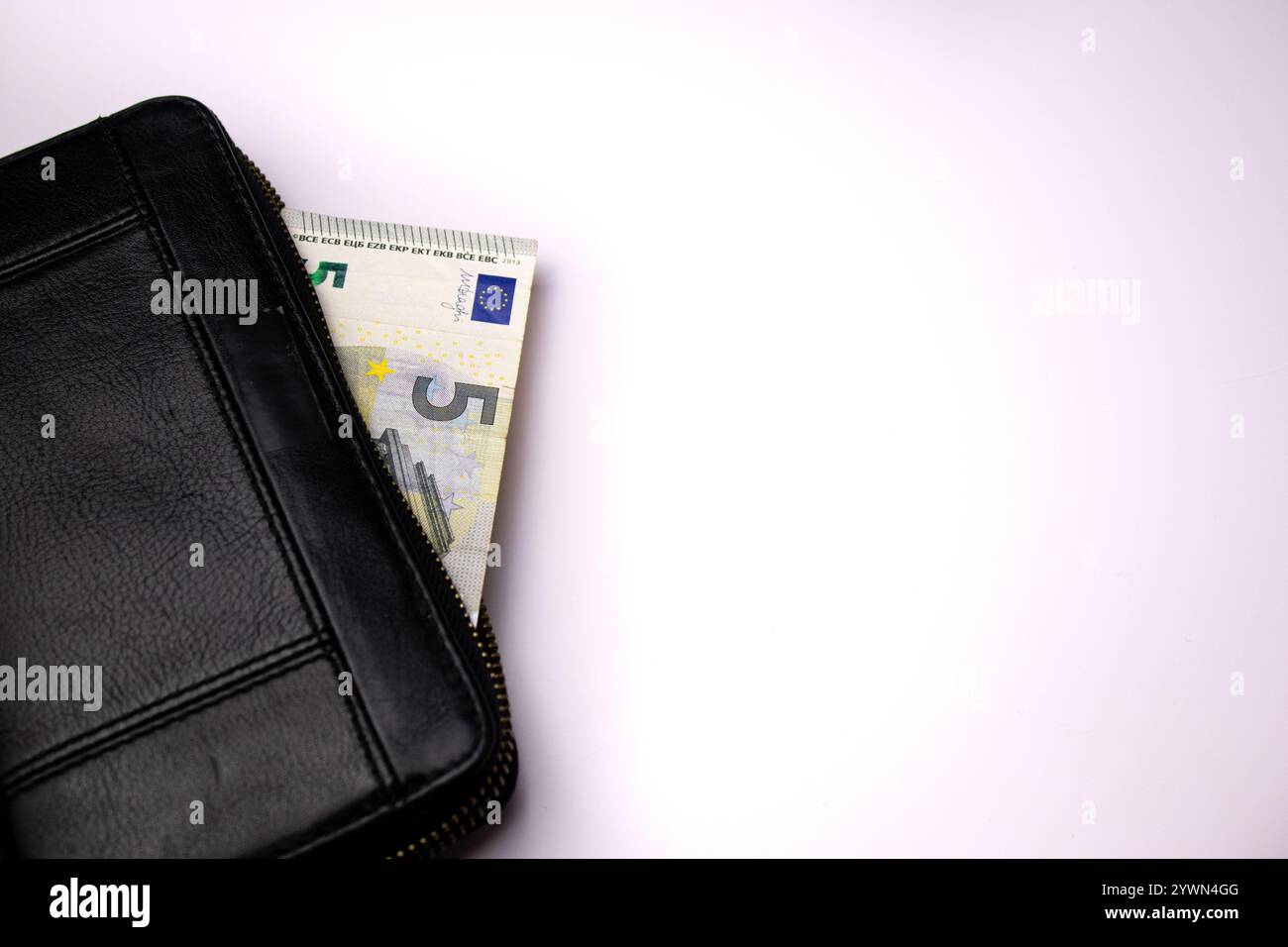 Black leather wallet with five euro bills banknotes on white background ...
