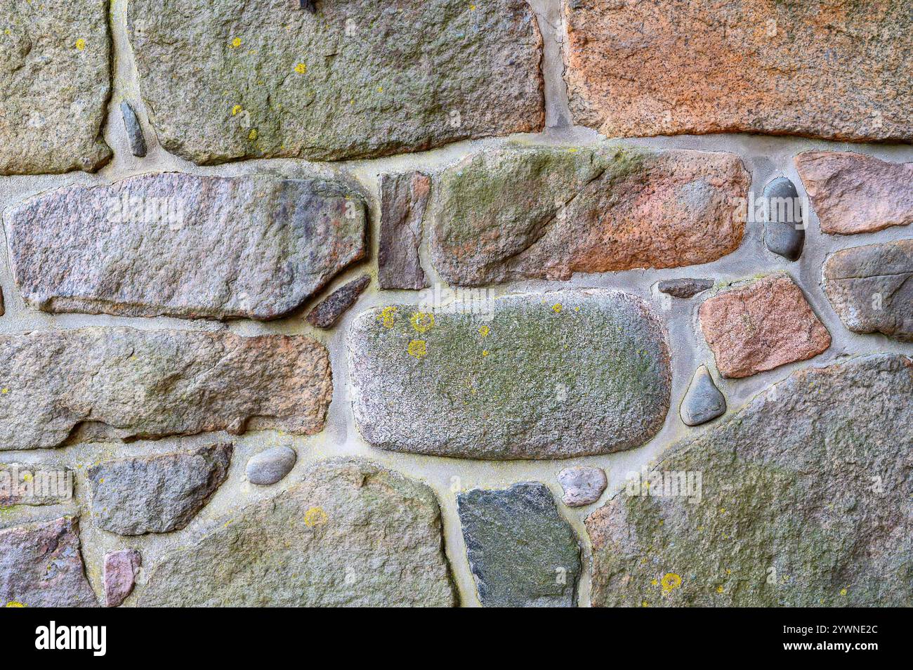 This rustic stone wall features a mix of different stone shapes and ...