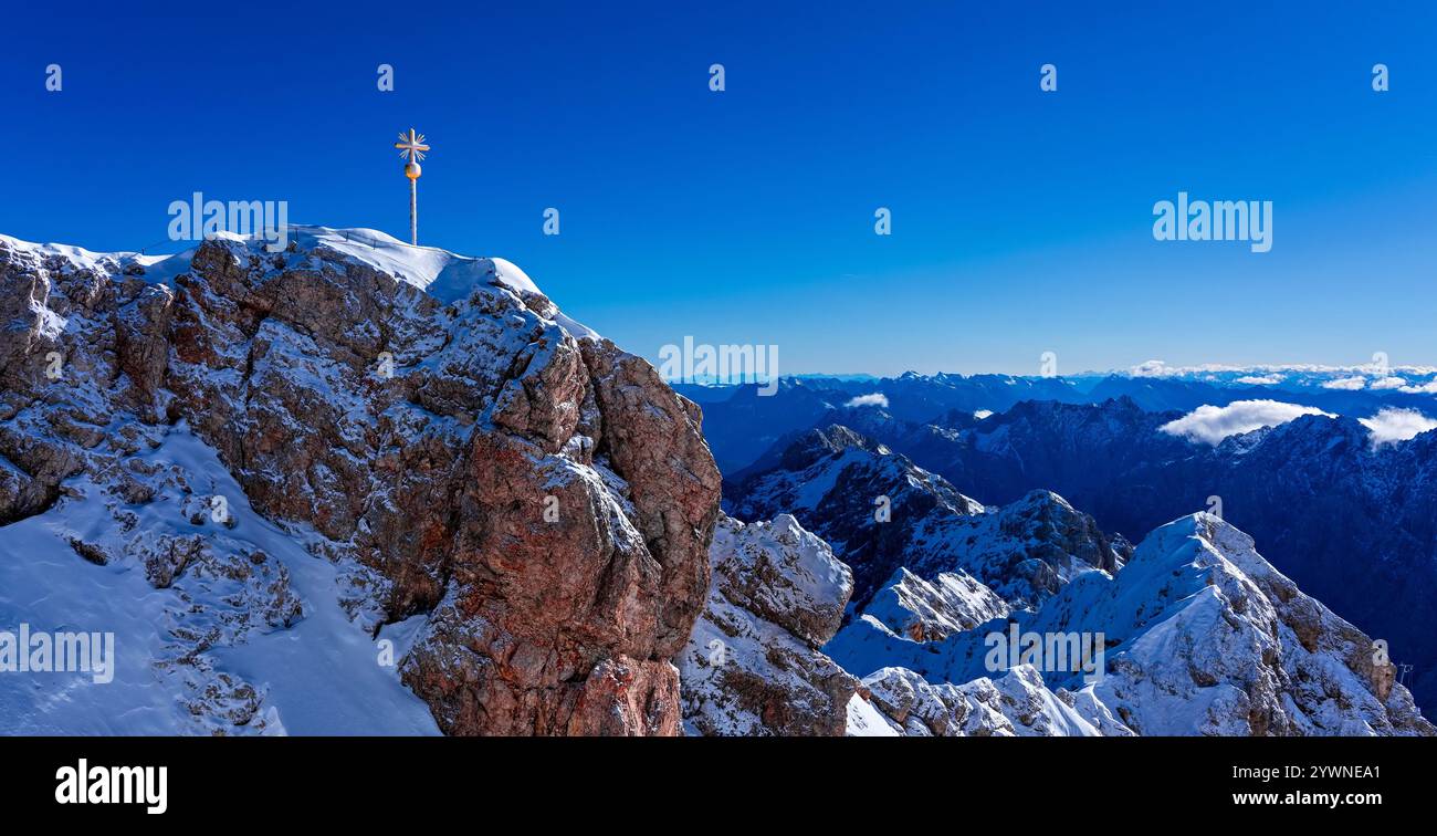View of the summit cross on the Zugspitze, the highest mountain peak in ...