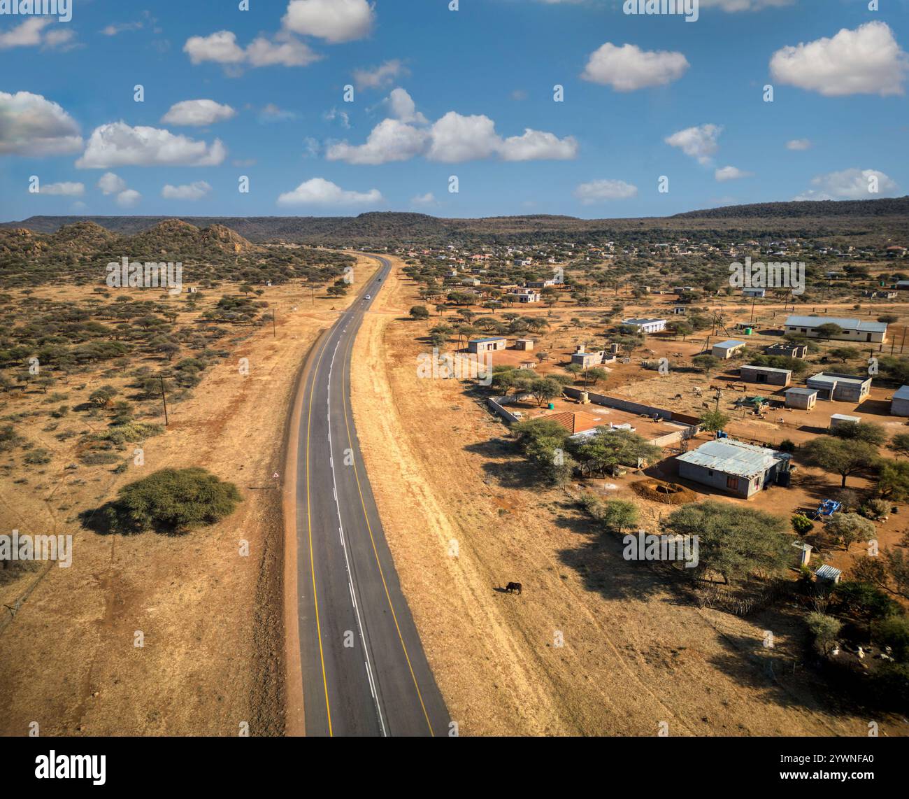 aerial view african village , highway road in the middle, typical ...