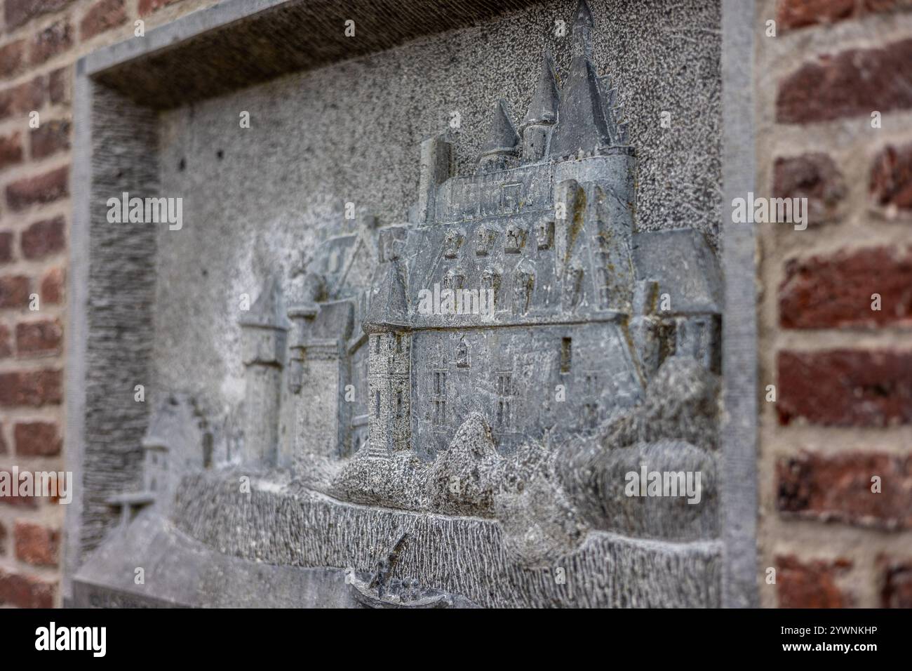A close-up of a detailed stone relief depicting a historic castle with ...