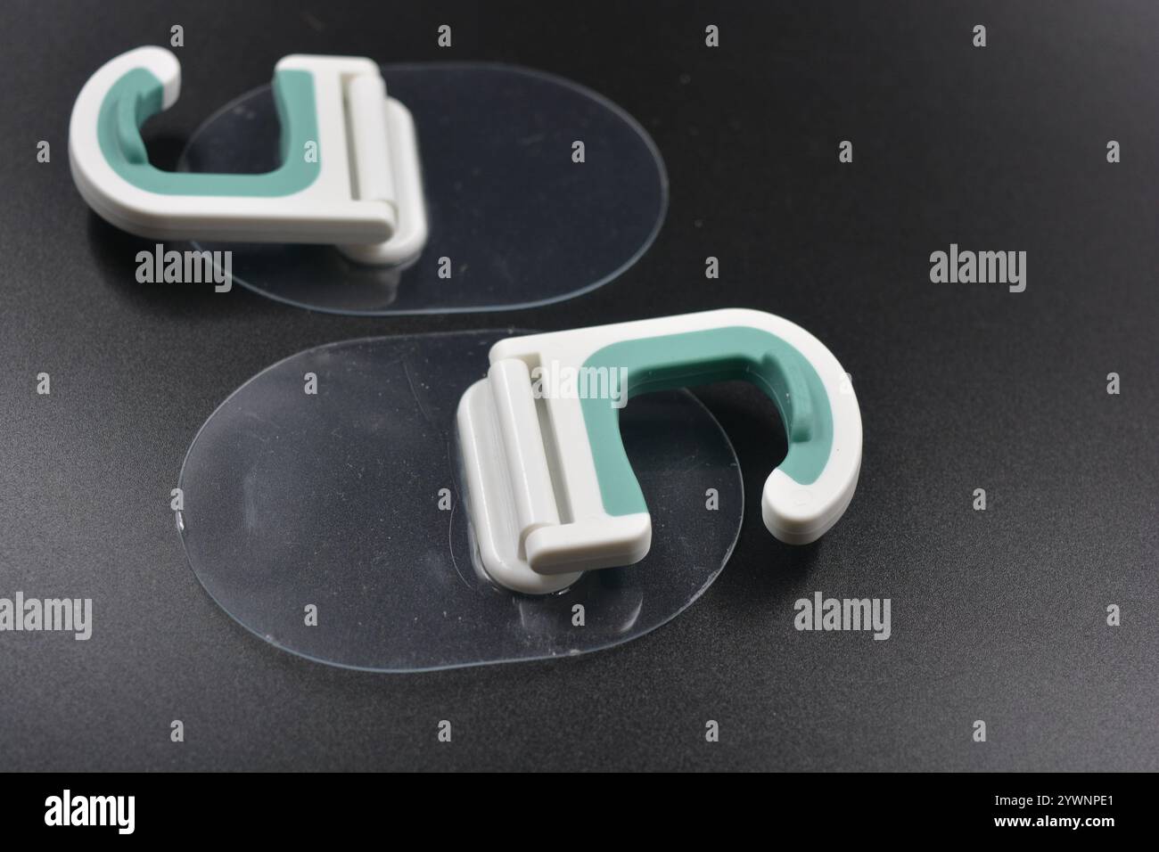 White and green plastic hooks for fixing the mop, things are located on ...