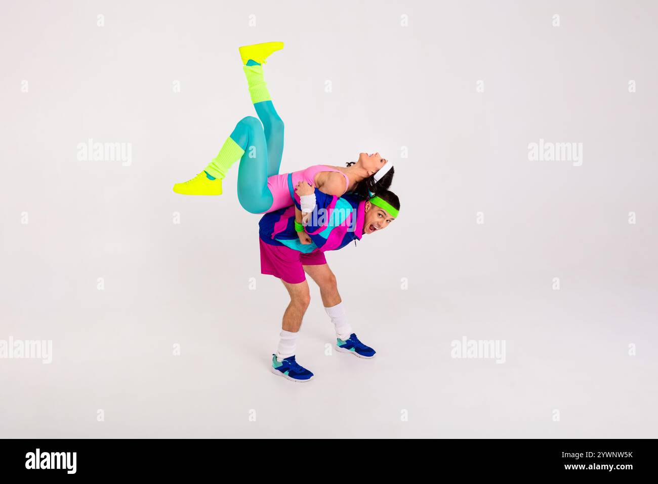 Retro fitness enthusiasts in vibrant sportswear display a dynamic dance ...