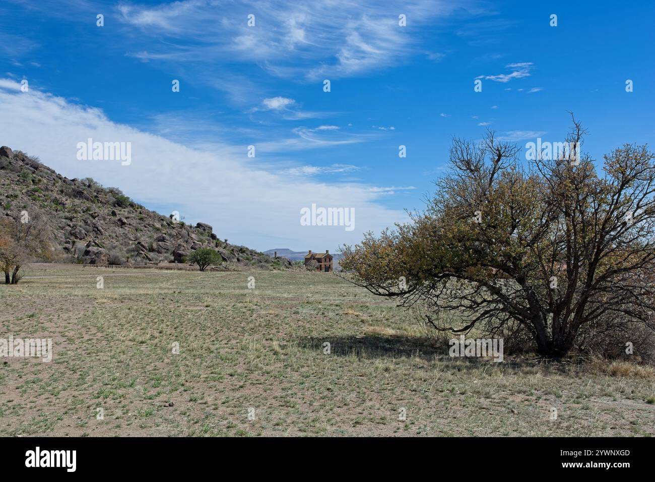 Arid fields with distant 19th century house ruins of Fort Davis ...