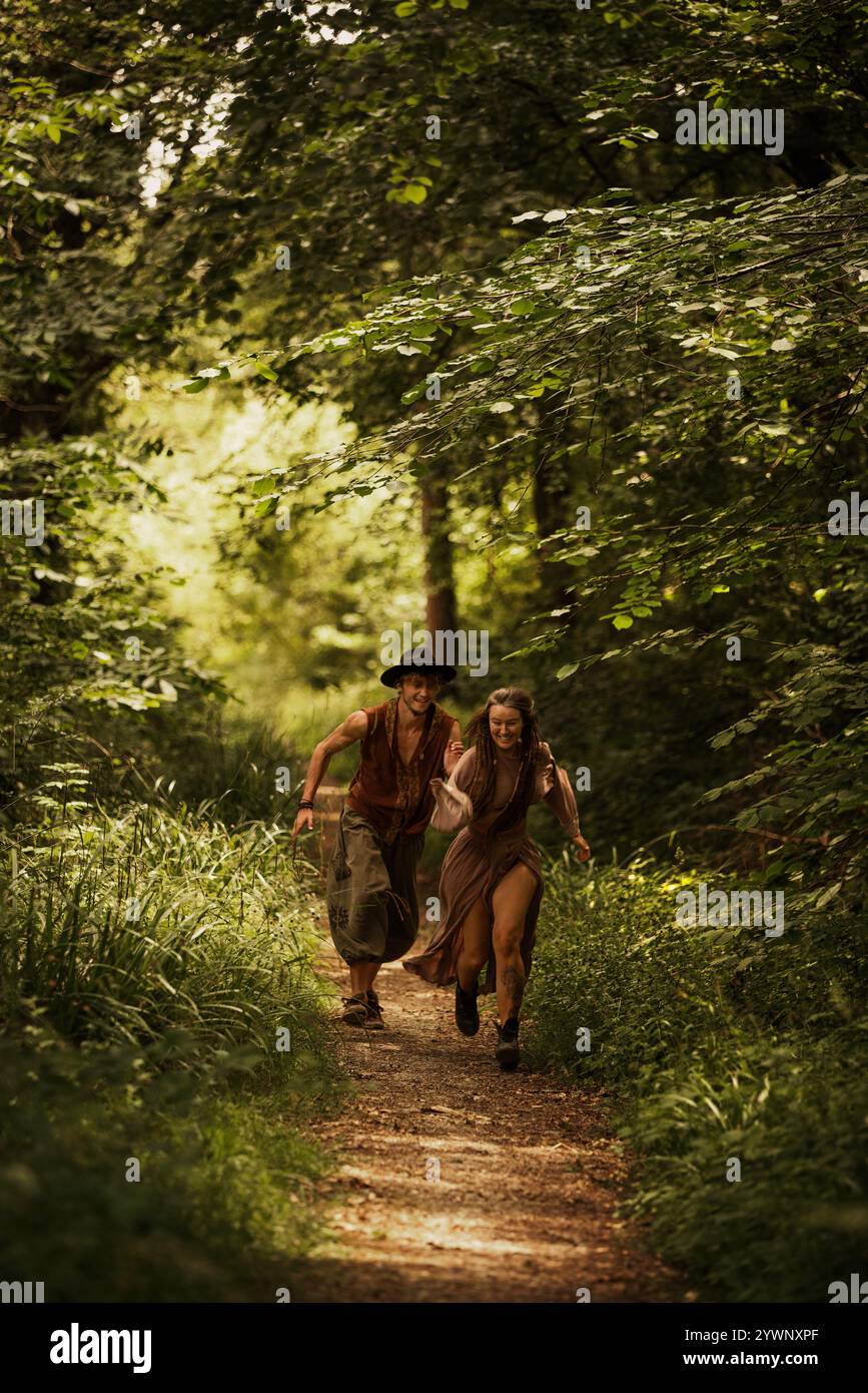 kiss chase couple running after each other in the forest Stock Photo ...