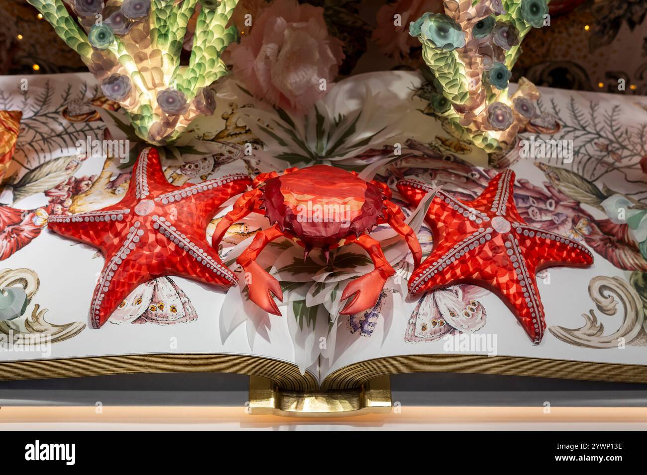 Paper composition - red crab on a large open book - installation Stock ...